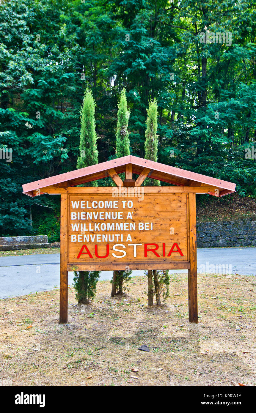 wooden signboard that announces the welcome in Austria to tourists and ...