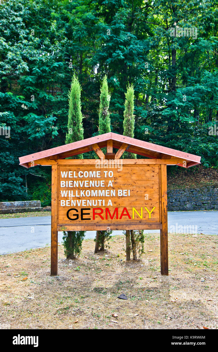 wooden signboard that announces the welcome in Gemany to tourists and ...