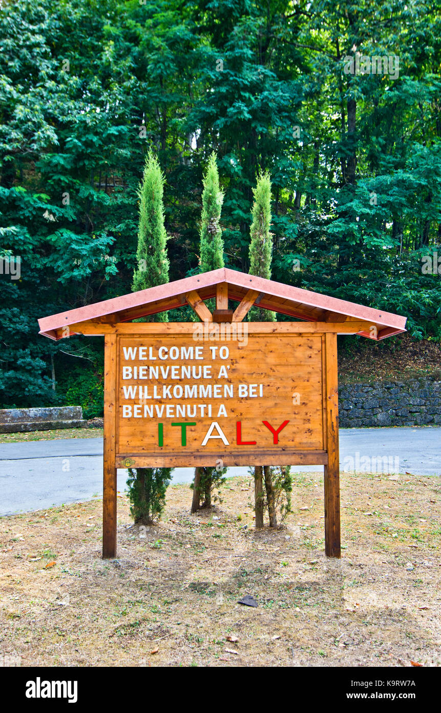 wooden signboard that announces the welcome in Italy to tourists and ...