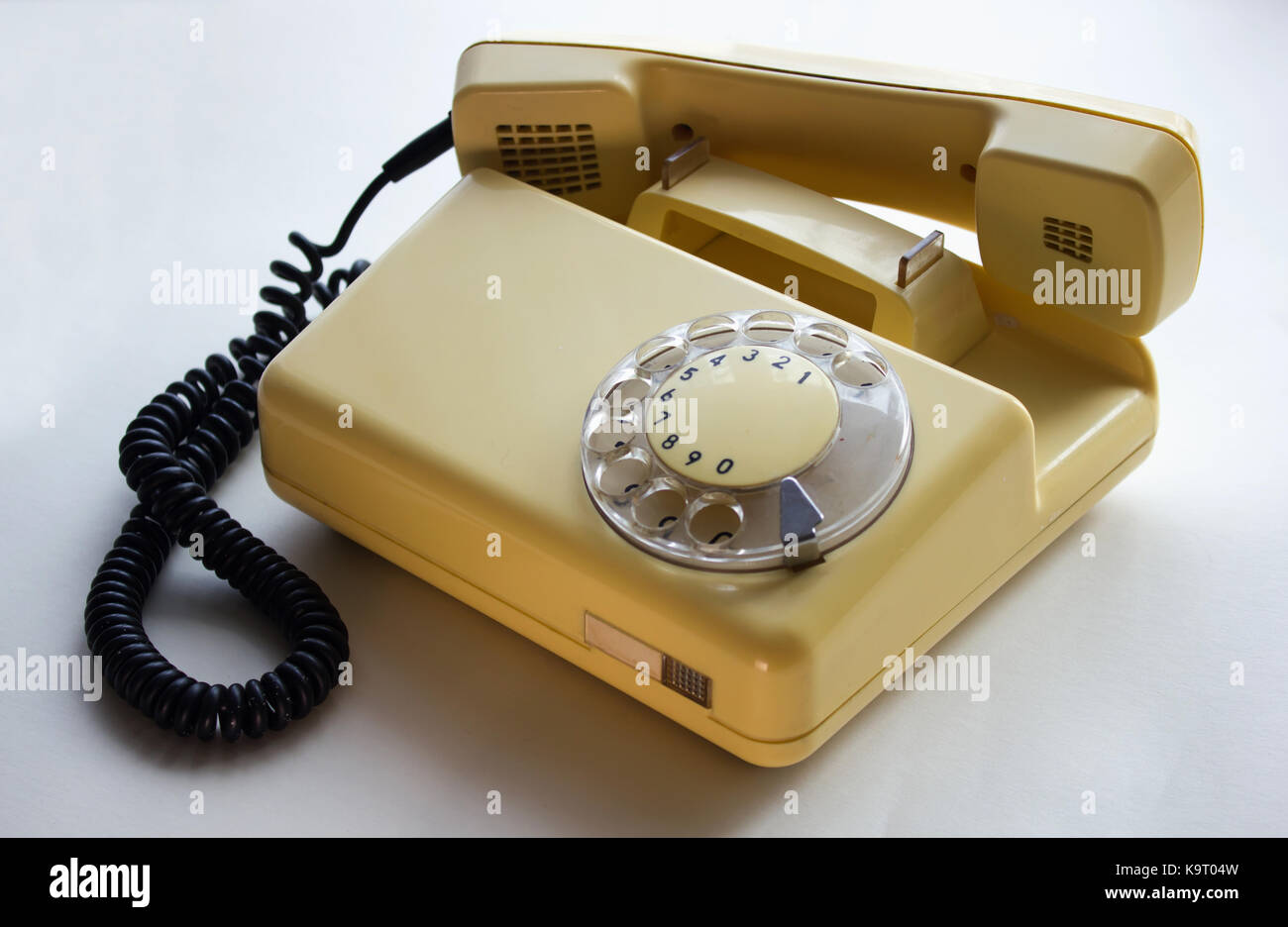 Vintage yellow telephone on а white background Stock Photo - Alamy