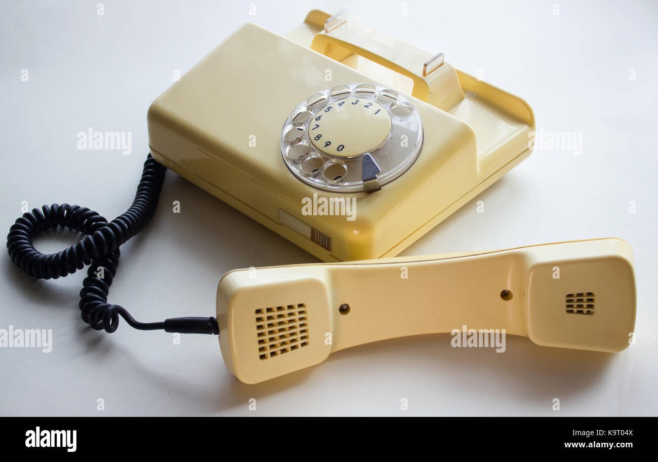 Vintage yellow telephone on а white background Stock Photo - Alamy