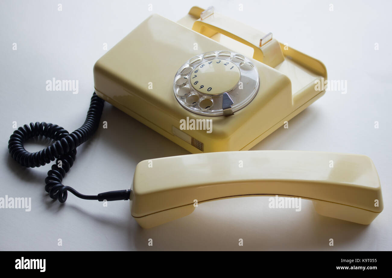 Vintage yellow telephone on а white background Stock Photo - Alamy
