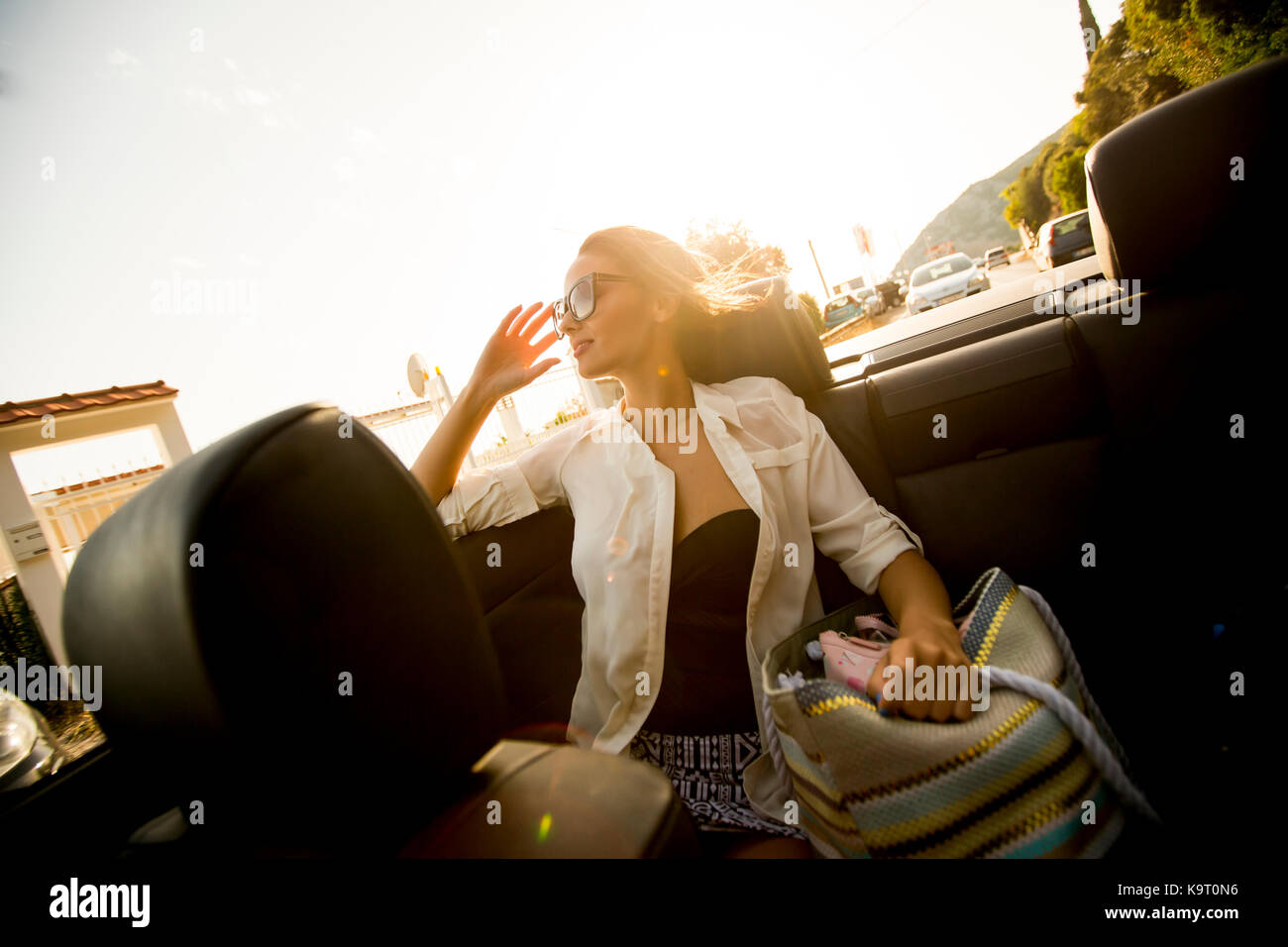 Pretty young woman driving in the cabriolet car at summer Stock Photo ...