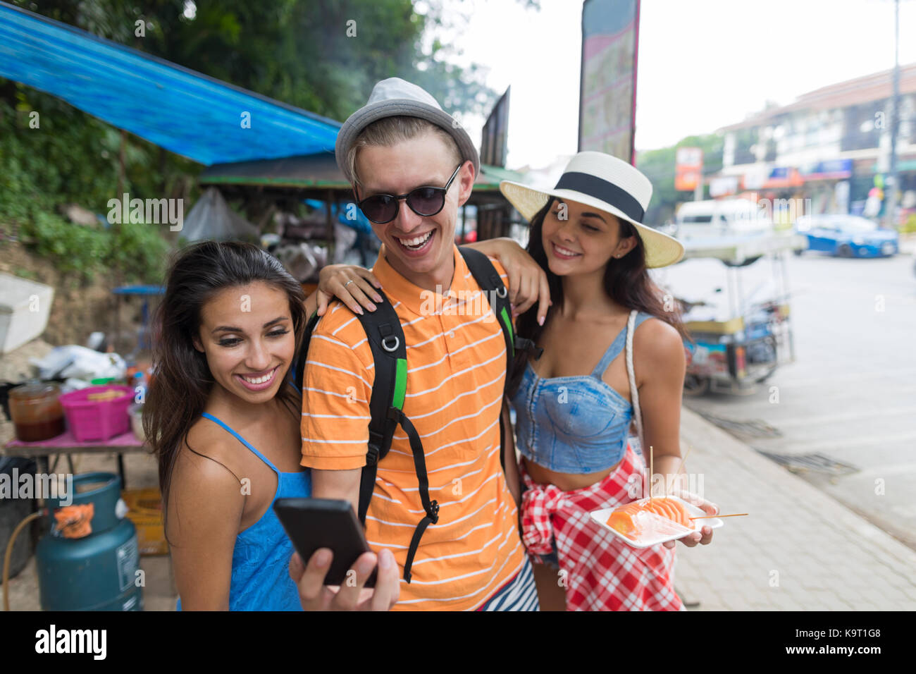 Group Of Tourists Use Mobile Phone To Find Rigt Direction Or For Selfie ...