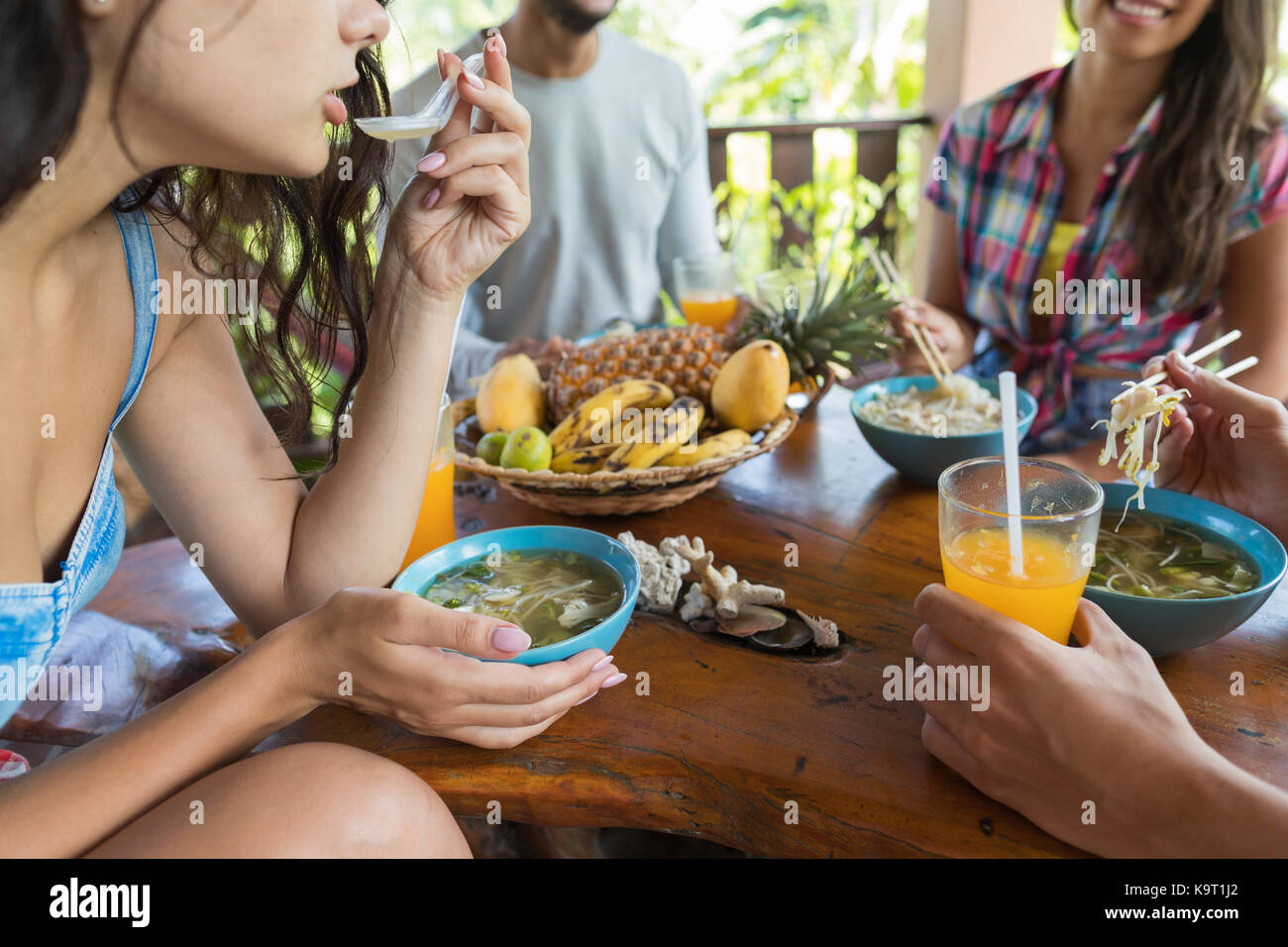 Closeup Shot Of Young People While Eating Noodles Soup Group Of Friends ...