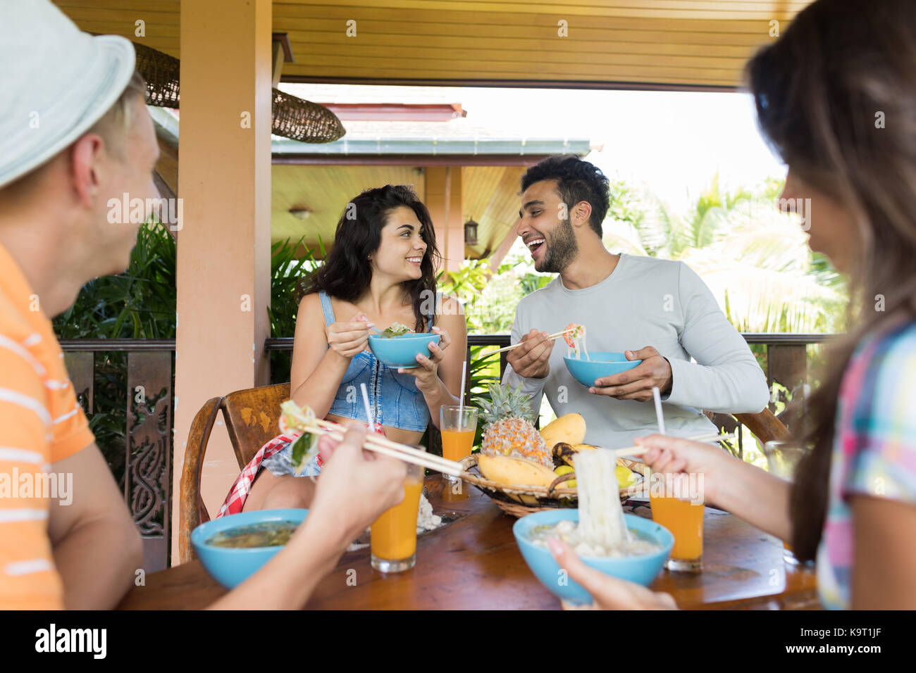 People Dining Together Eating Asian Noodles With Chopsticks Happy ...