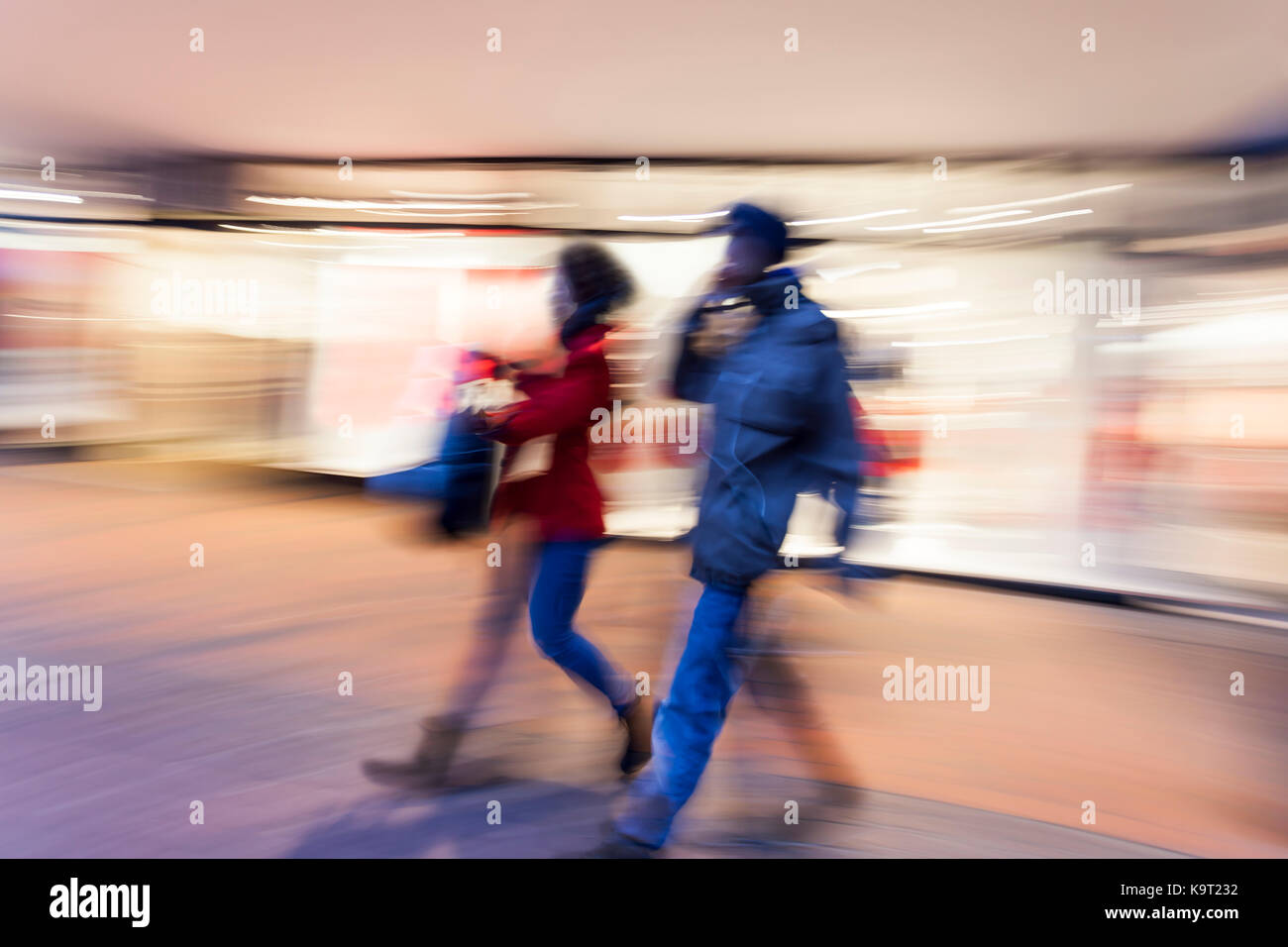 Shopper walking in front of shop window Stock Photo - Alamy