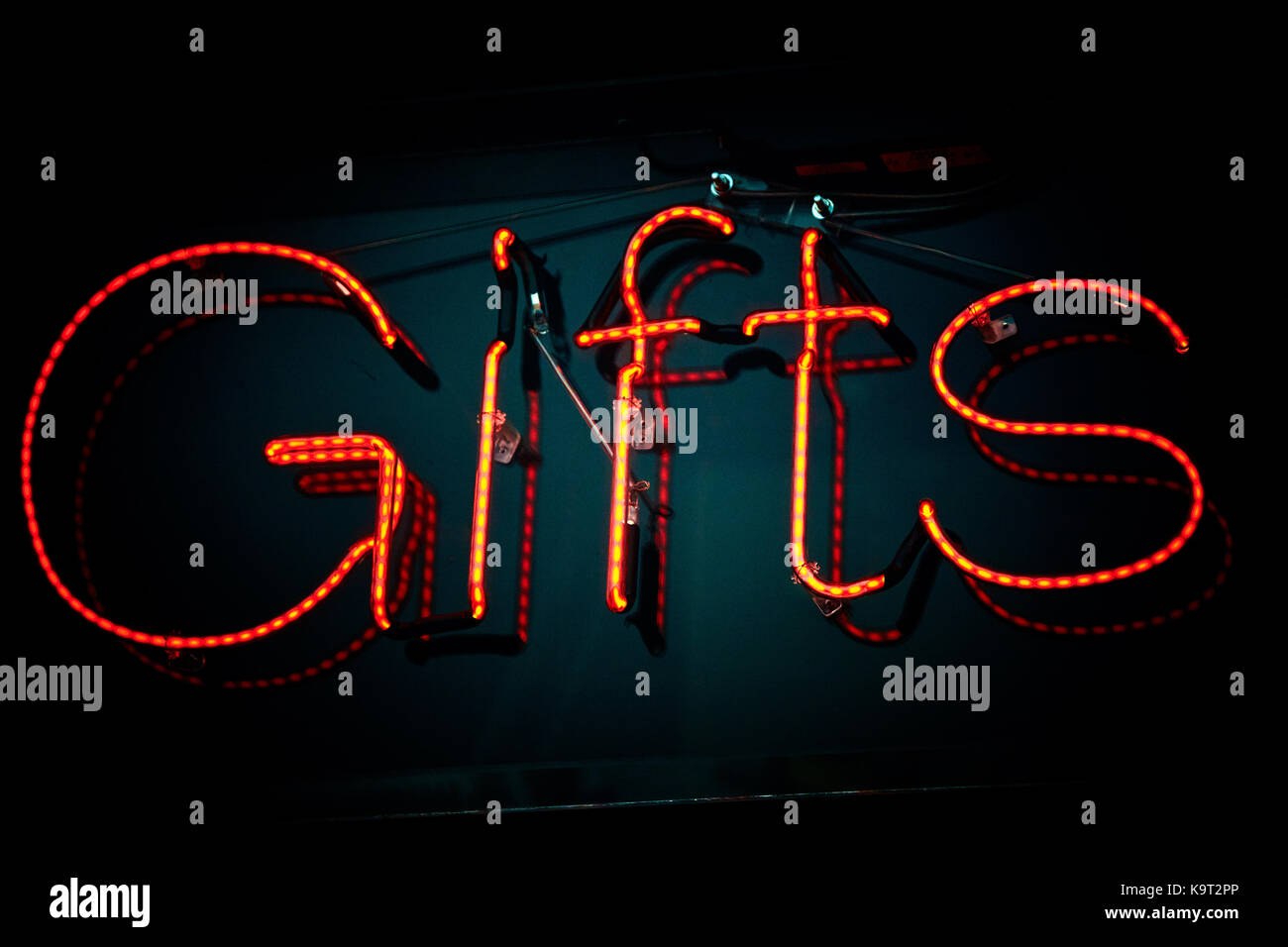 A neon sign advertising a gift shop Stock Photo - Alamy