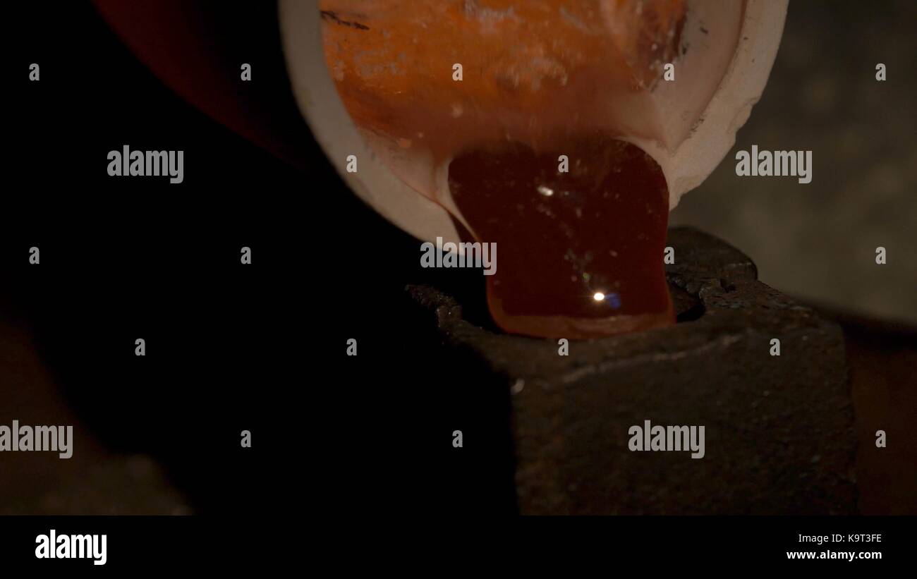 Shaping molten metal. Steel Factory. Liquid iron flowing in steelworks ...