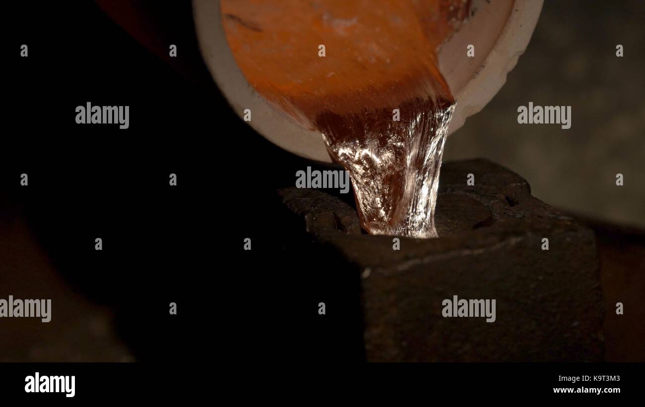 Shaping molten metal. Steel Factory. Liquid iron flowing in steelworks ...