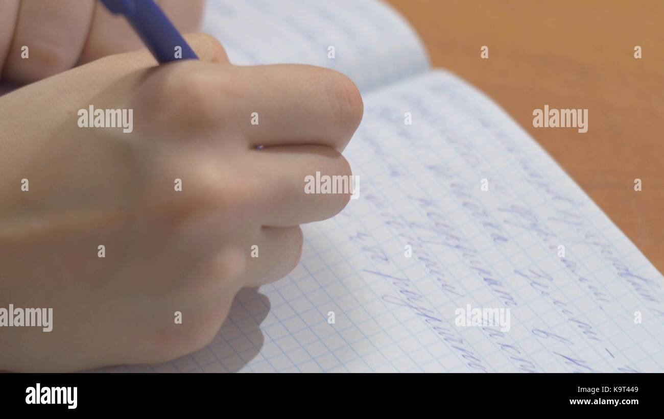 Female hands with pen writing on notebook. Close up of woman's hands ...