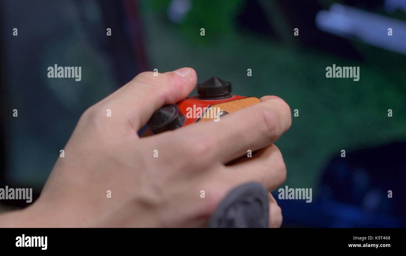 Young man plays video game with a retro joystick. Gaming joystick from ...