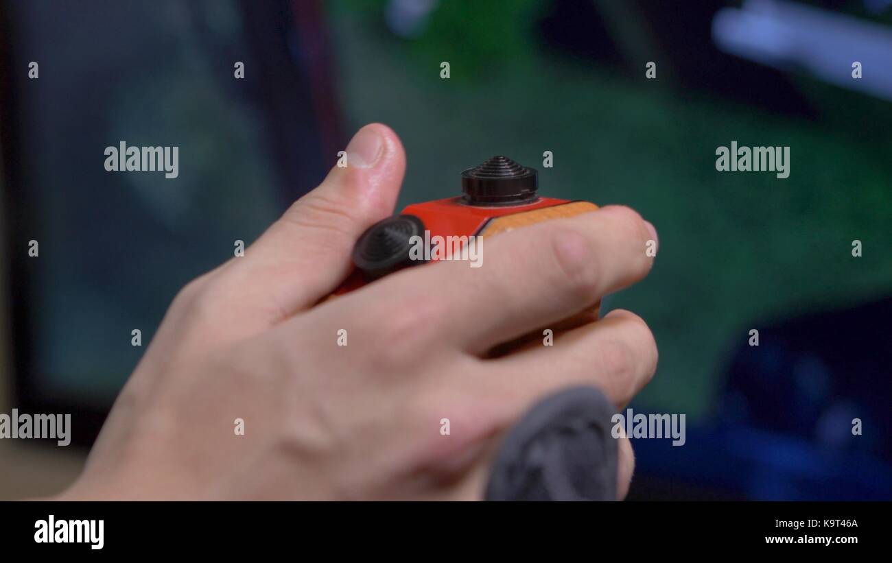 Young man plays video game with a retro joystick. Gaming joystick from ...