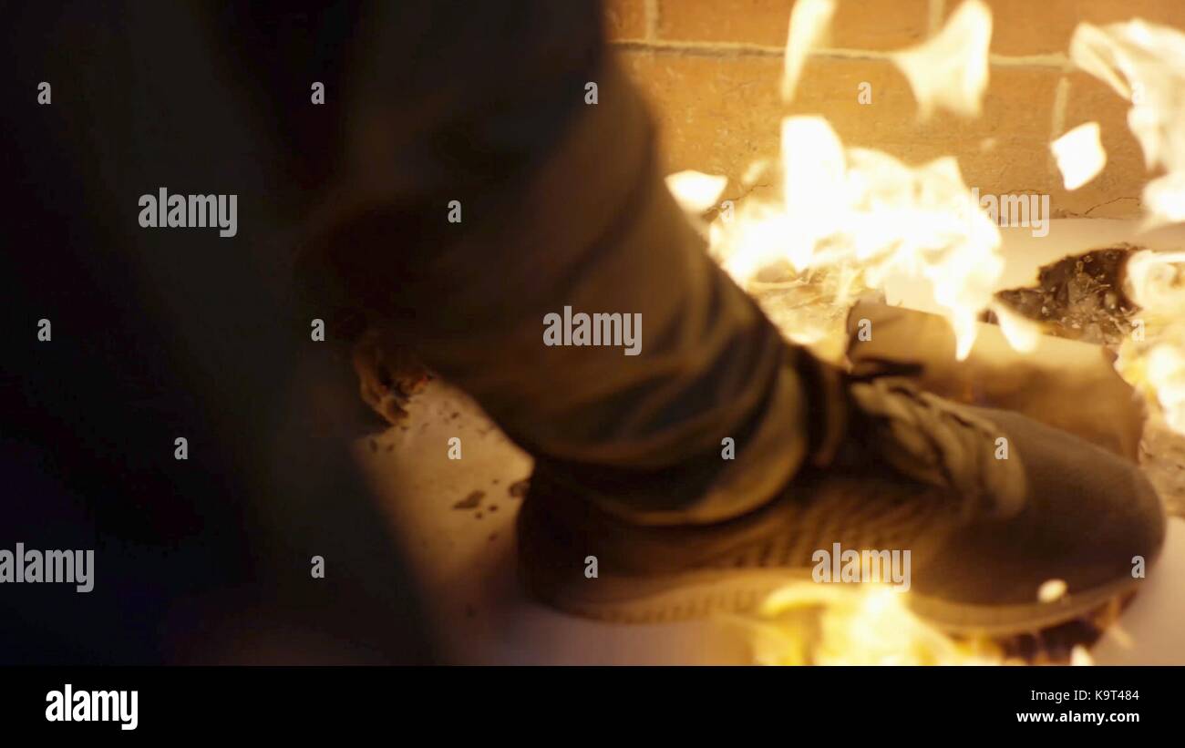 Man puts out fire using foot. Man Extinguishing a campfire Stock Photo ...