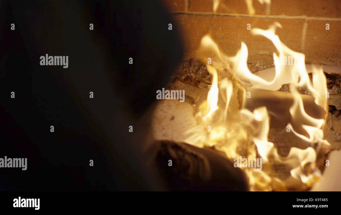 Man puts out fire using foot. Man Extinguishing a campfire Stock Photo ...