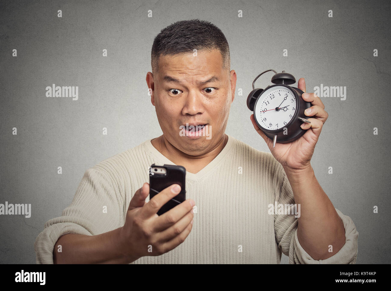 Headshot portrait surprised shocked man with alarm clock looking at ...