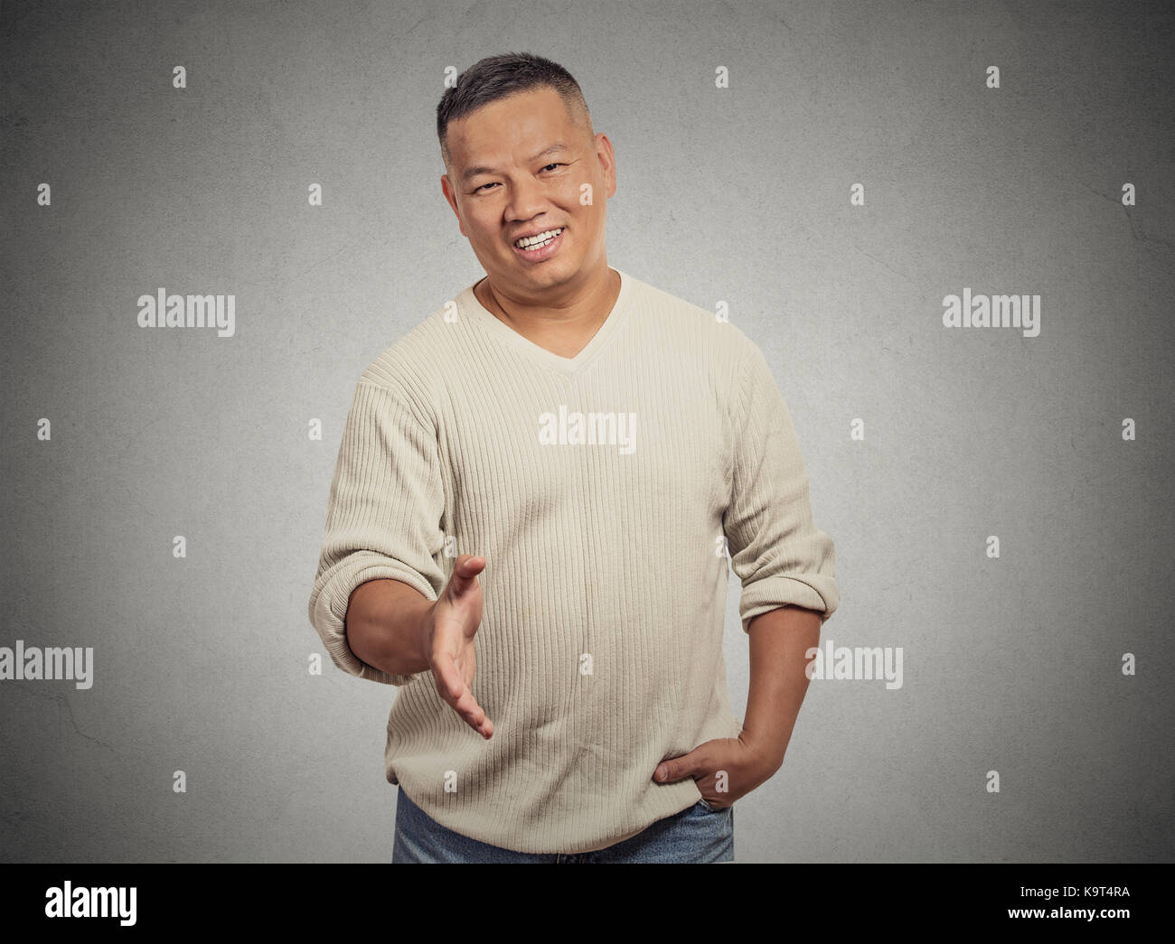 Closeup portrait handsome young adult smiling man giving extending arm ...