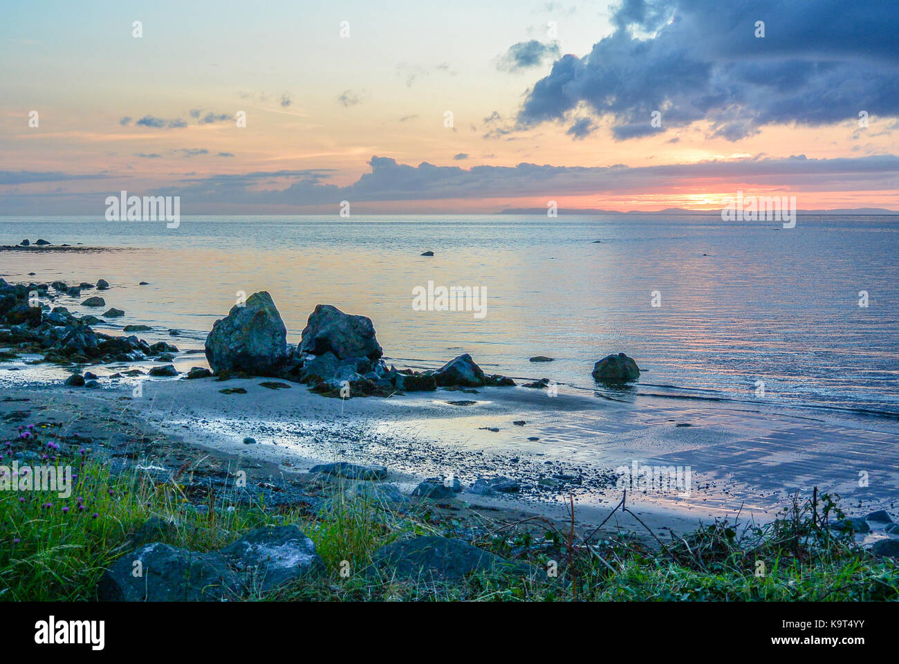 Sunset with red skies over the sea and beach from Lendalfoot near ...