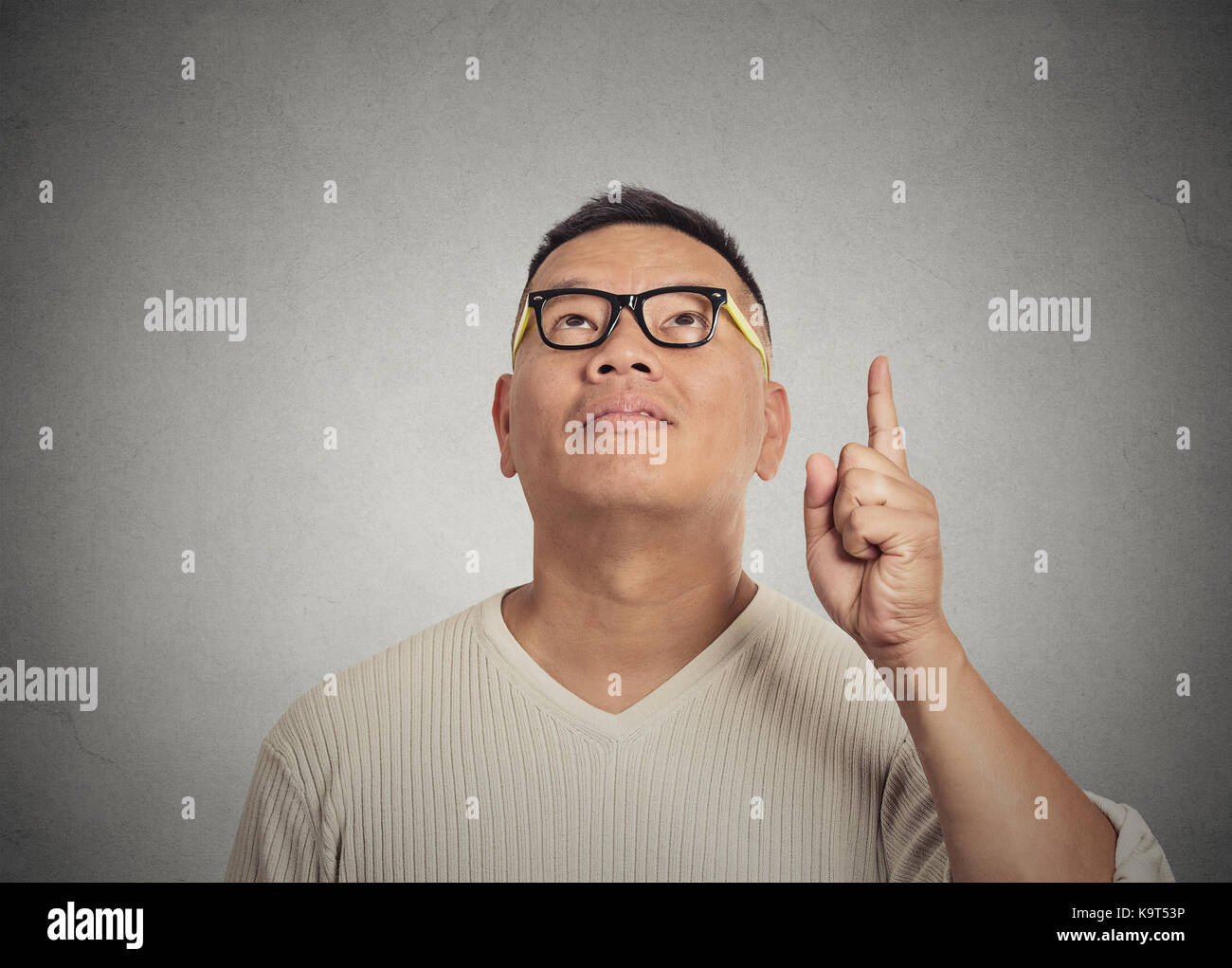 Portrait young man has an idea, pointing with finger up isolated on ...
