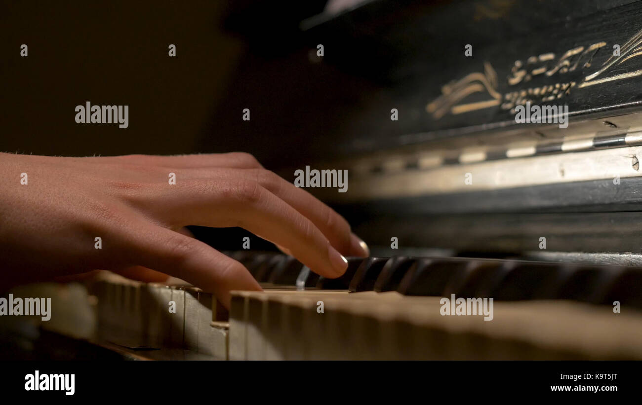 A young woman playing piano closeup. Piano hands pianist playing ...