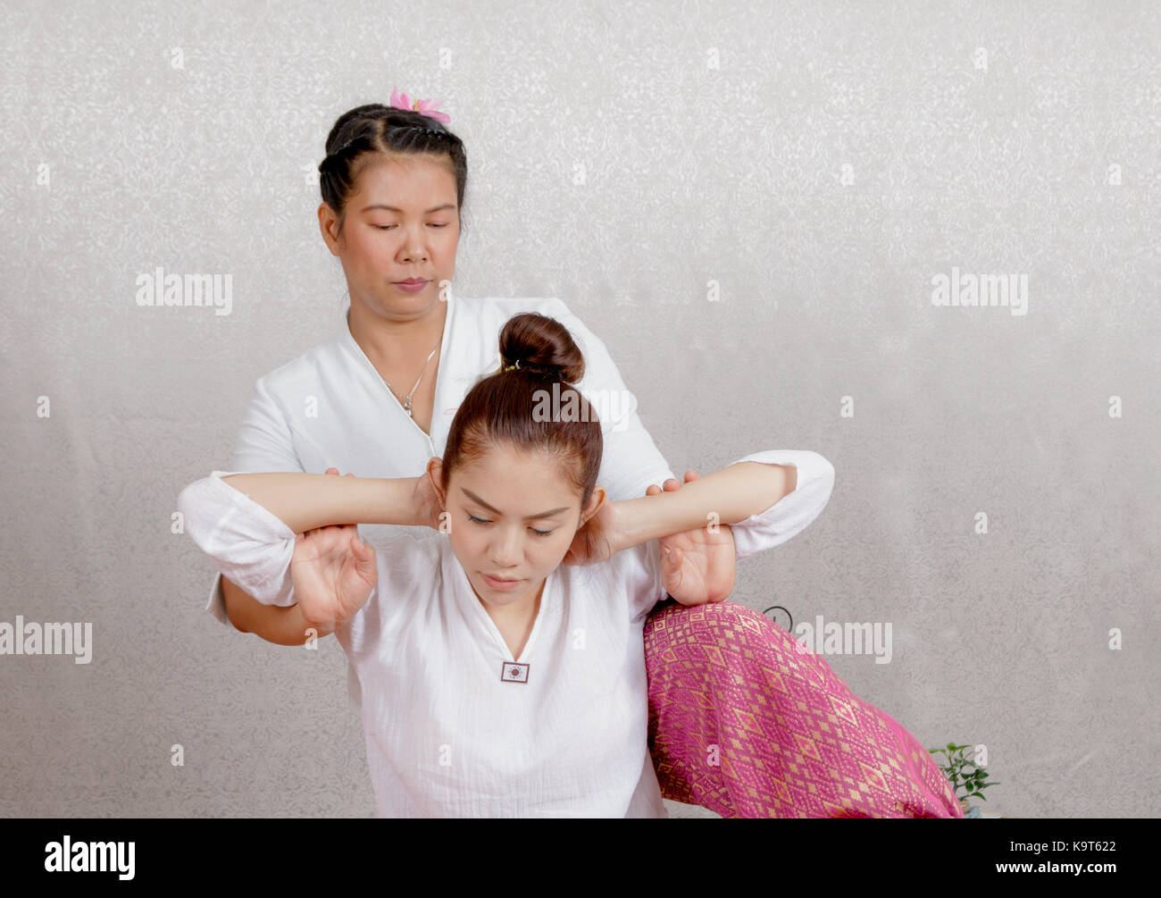Asian Woman Getting Traditional Thai Stretching Massage By Therapist