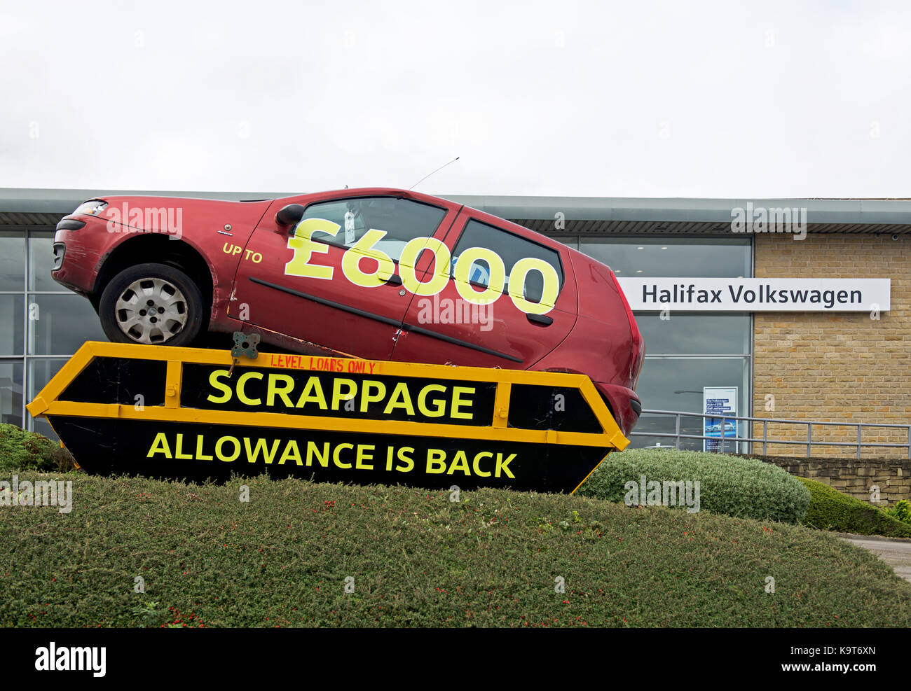 Car in a skip, publicising the car scrappage allowance, England UK ...