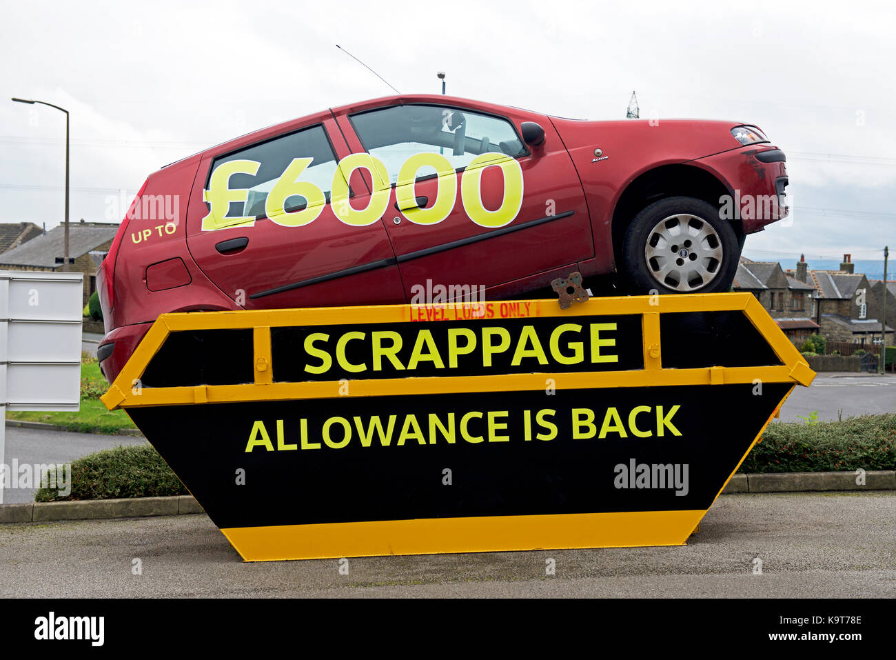 Car in a skip, publicising the car scrappage allowance, England UK ...