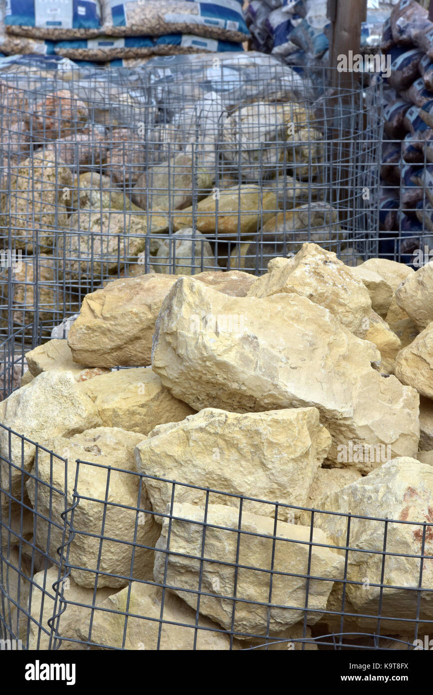 Building stones and materials in cages at builders merchants showing ...