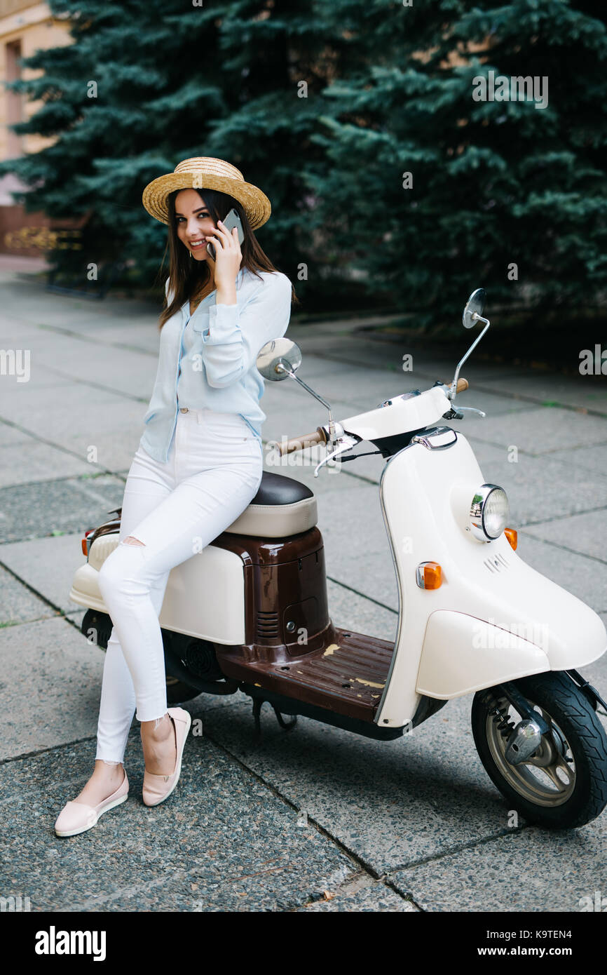 Woman on moped talking hi-res stock photography and images - Alamy