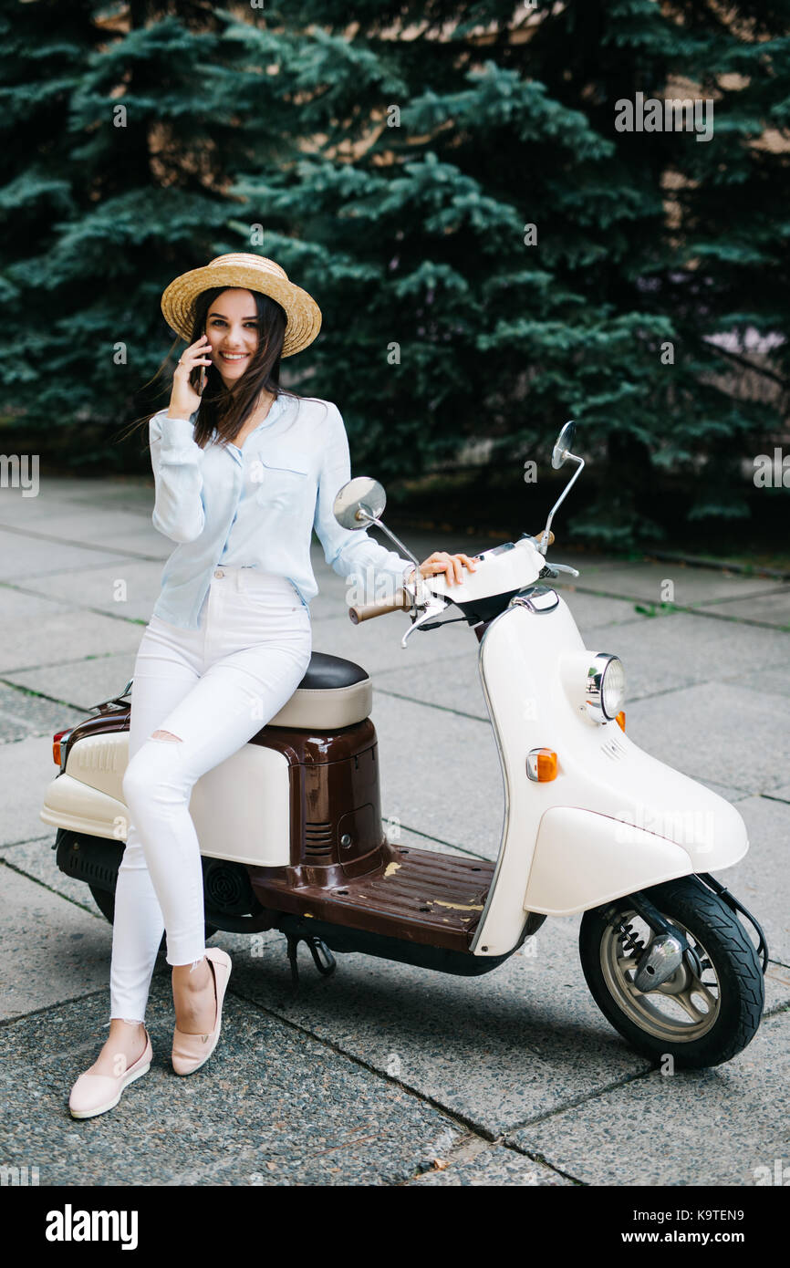 Woman on moped talking hi-res stock photography and images - Alamy