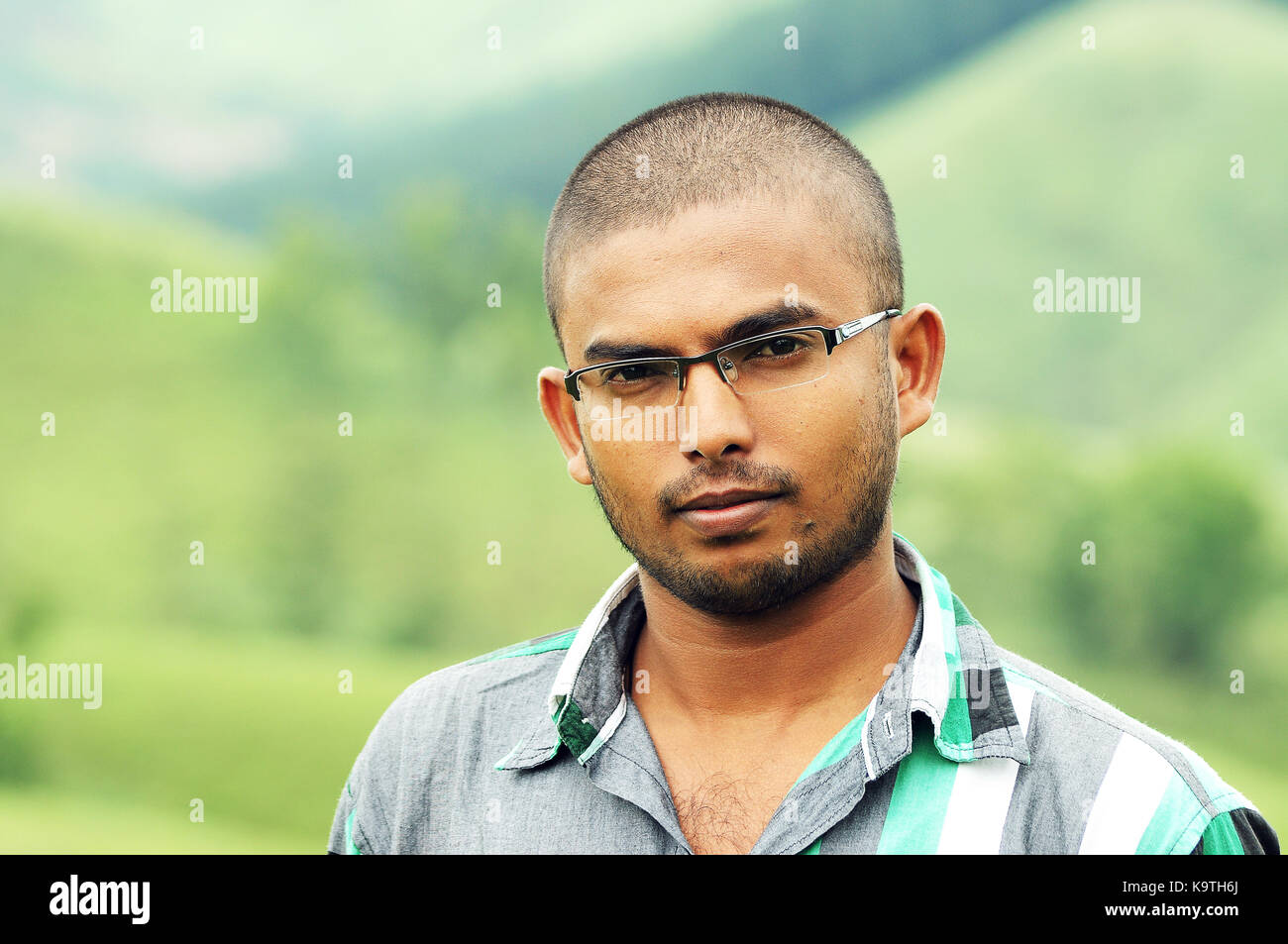 Handsome young man looking at camera Stock Photo - Alamy