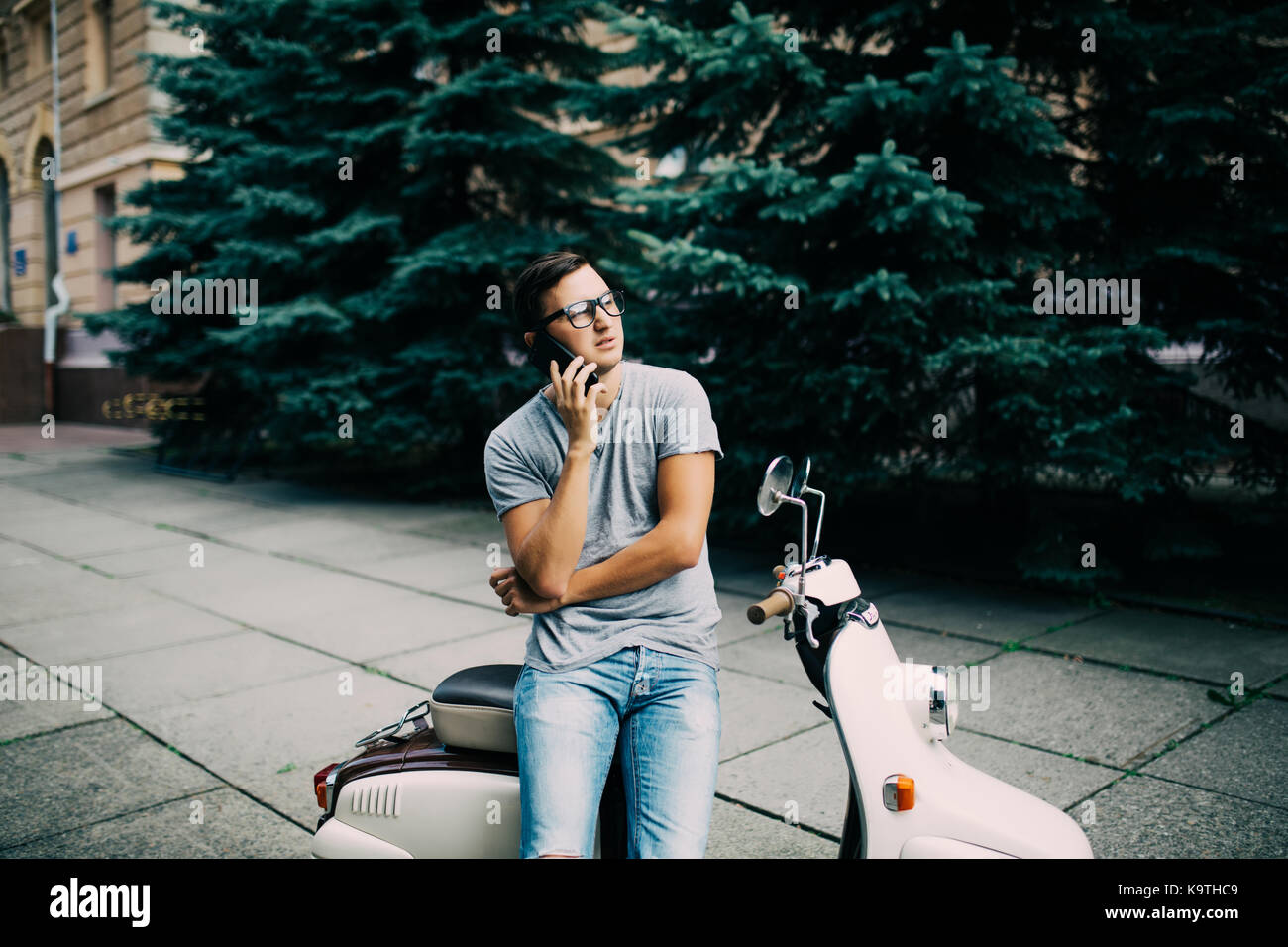 Young handsome man sitting on the motorbike talking on the phone Stock ...