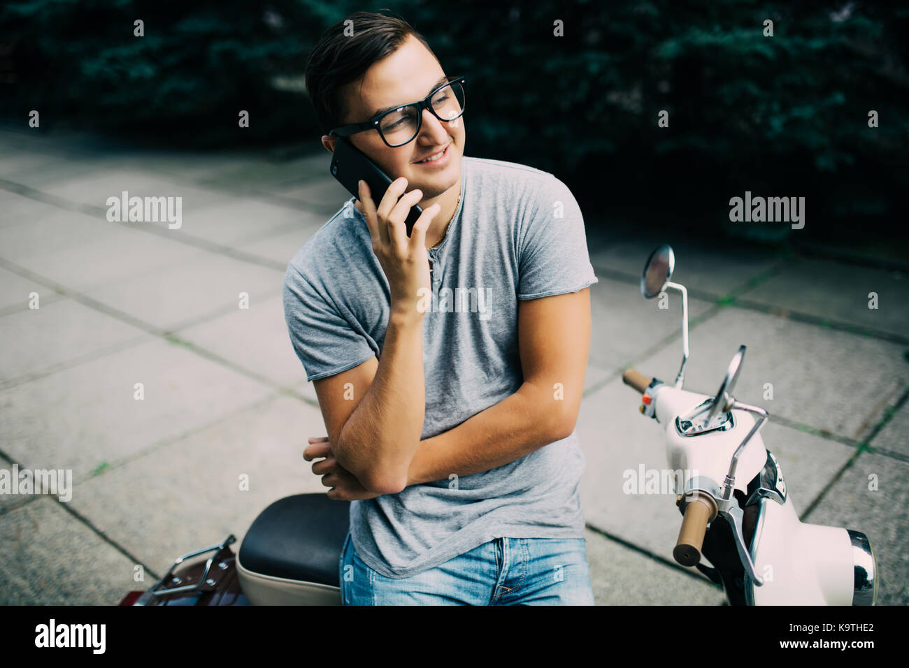 Young handsome man sitting on the motorbike talking on the phone Stock ...