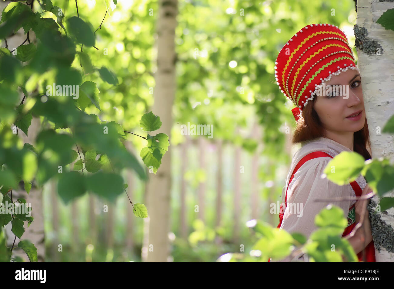 Slav in traditional dress hiding behind trees Stock Photo - Alamy