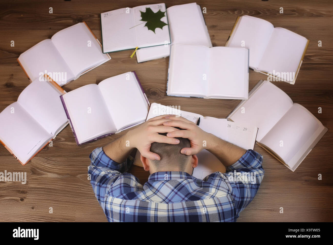 man working with book on the floor Stock Photo - Alamy
