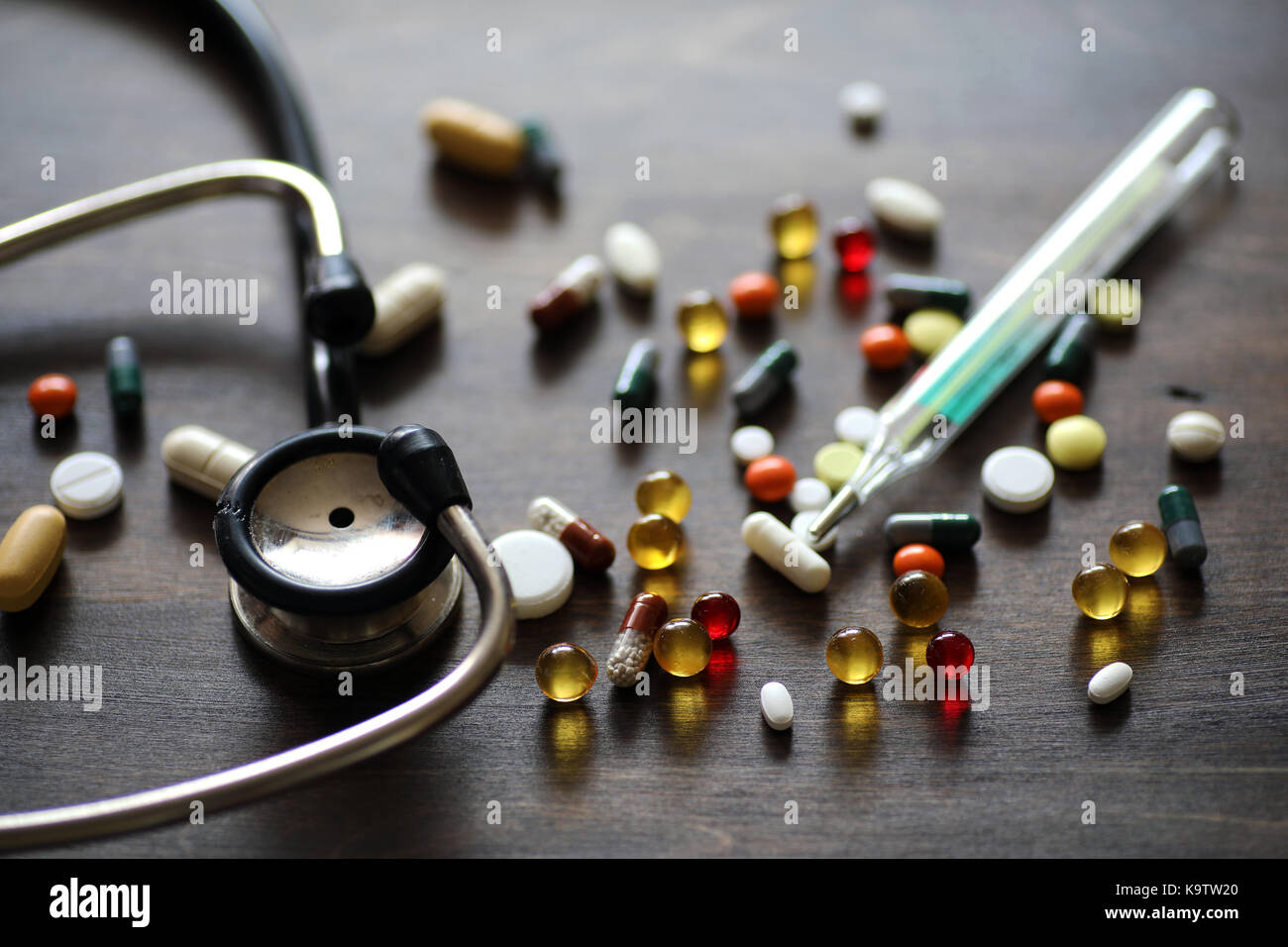 Medications and tablets on a wooden texture table Stock Photo - Alamy