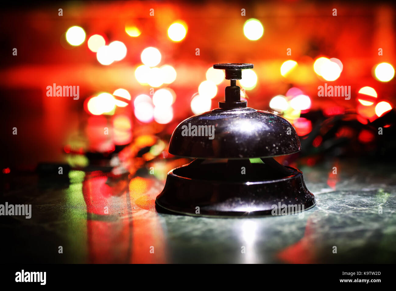 reception bell on table and color shining garland on background Stock ...
