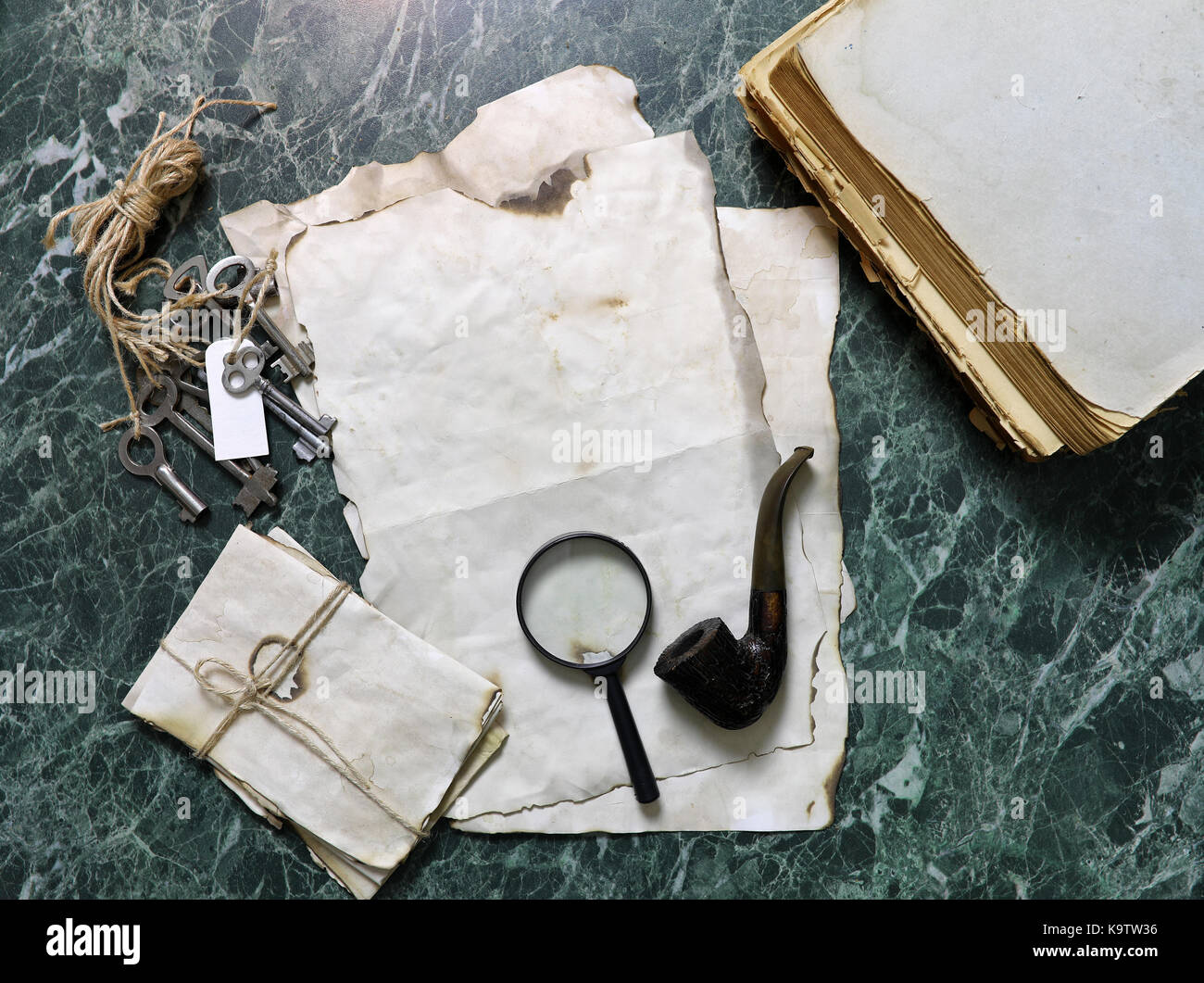 retro papers and book on detective work table with tools Stock Photo ...