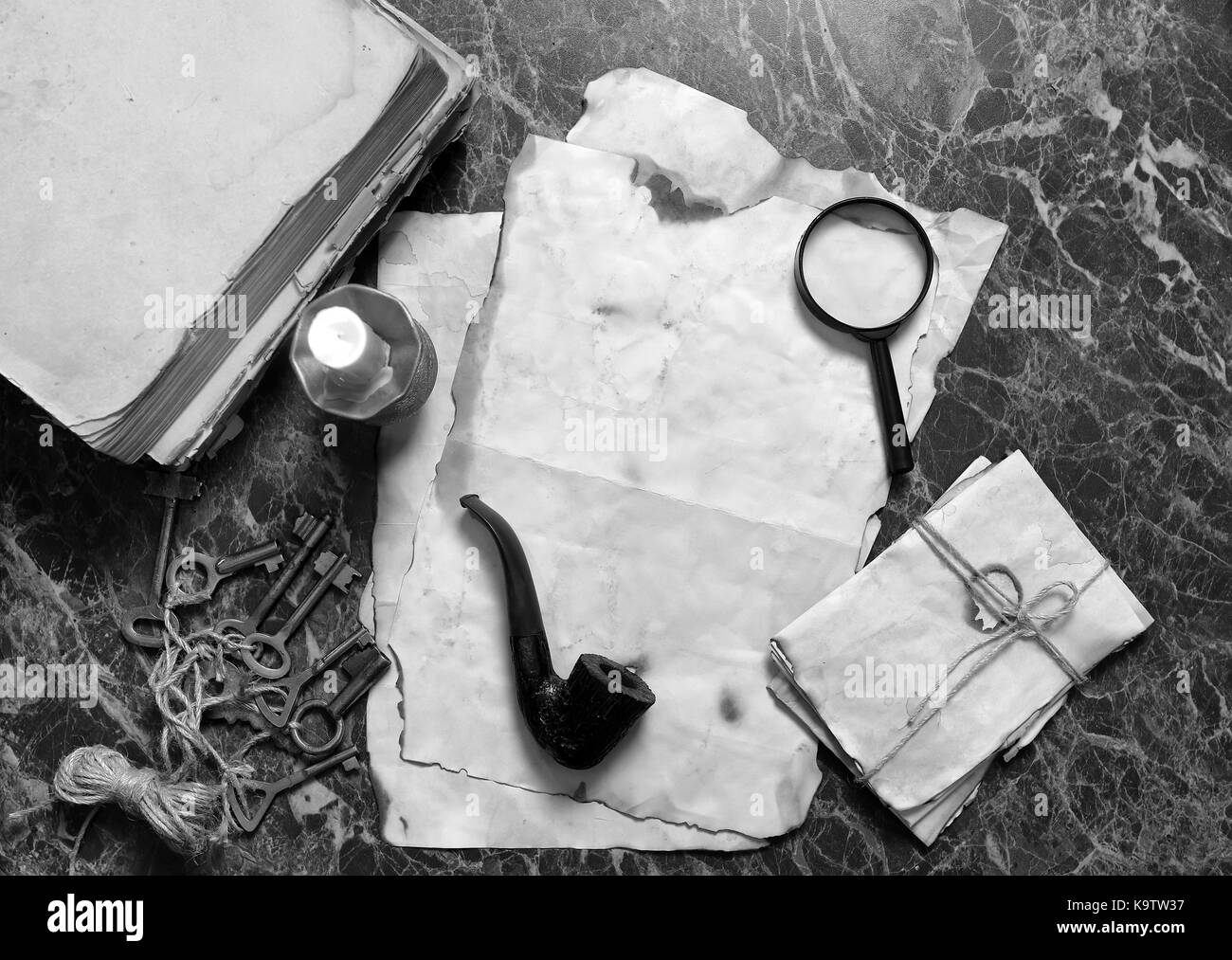 papers and book on detective work table with tools Stock Photo - Alamy