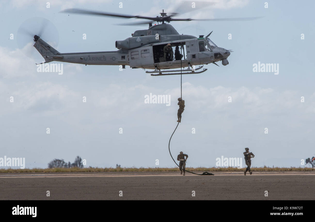 Marines with 1st Marine Division fast rope from a UH-1Y Huey Stock ...