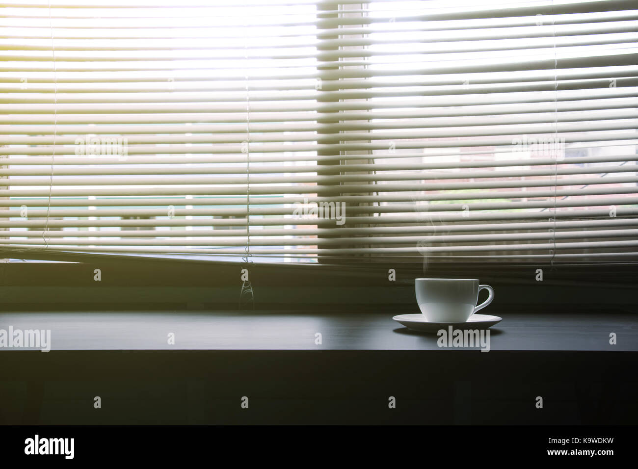 Coffee cup is located by the window Stock Photo - Alamy