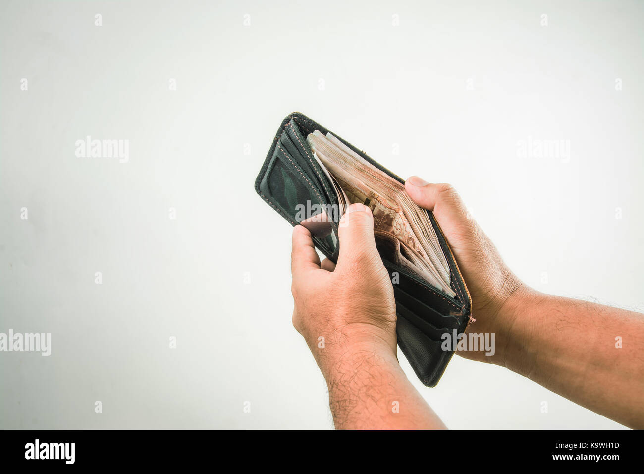wallet in hand on white background Stock Photo - Alamy
