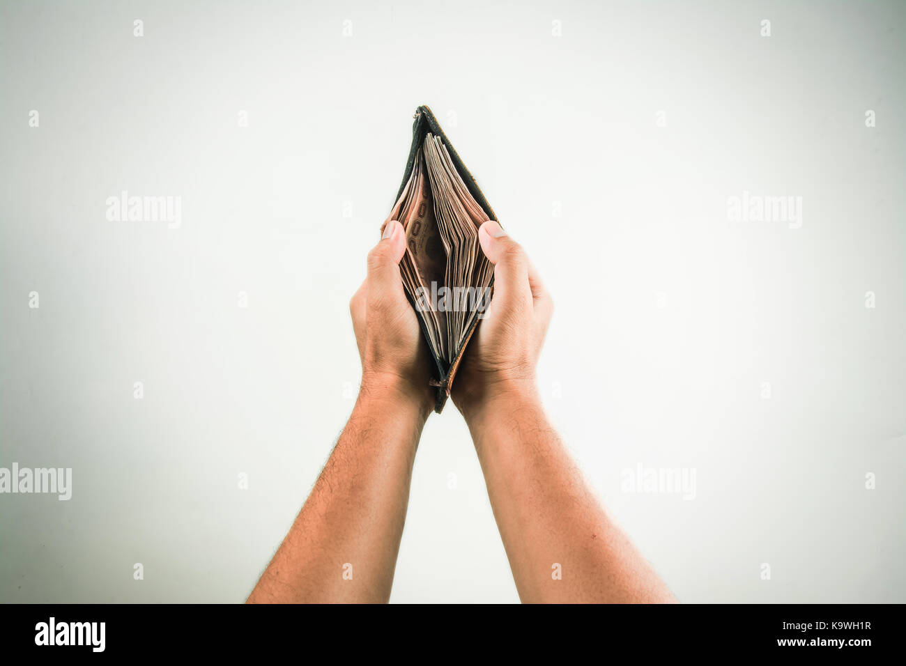 wallet in hand on white background Stock Photo - Alamy