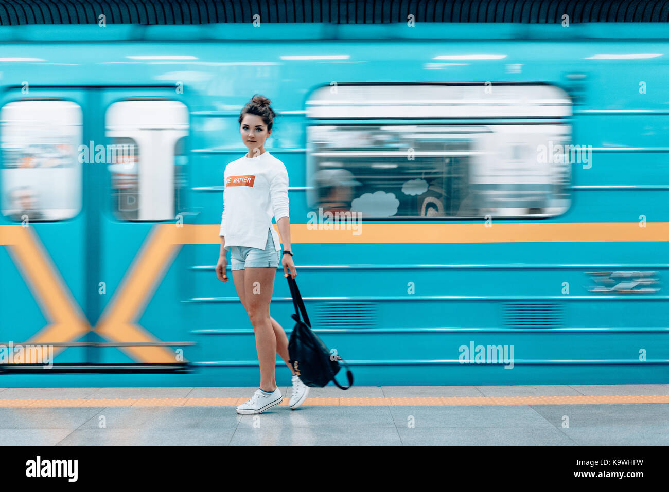 Beautiful young girl posing on metro station Stock Photo - Alamy