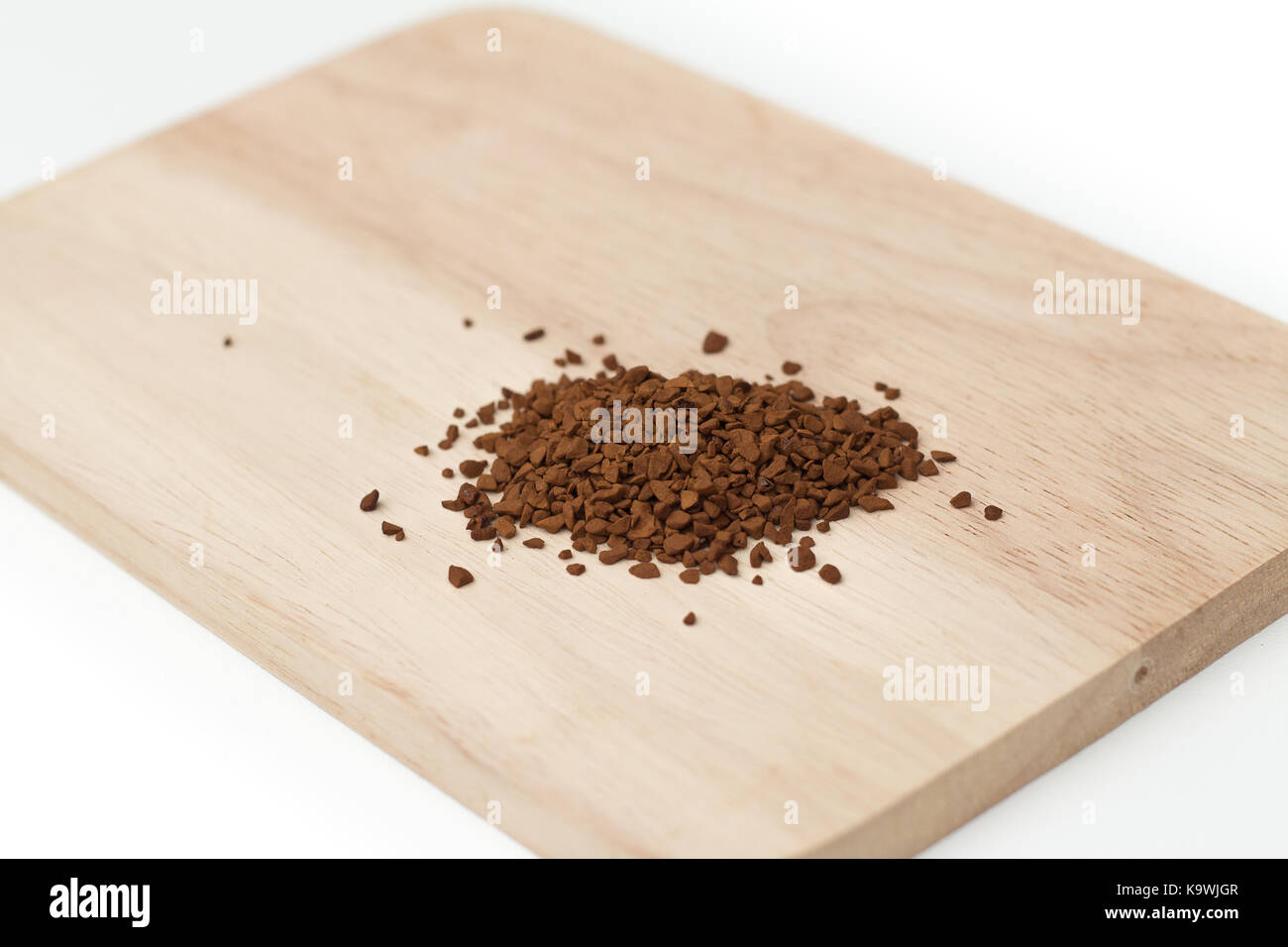 Instant coffee powder on wood plate and isolated on white background ...