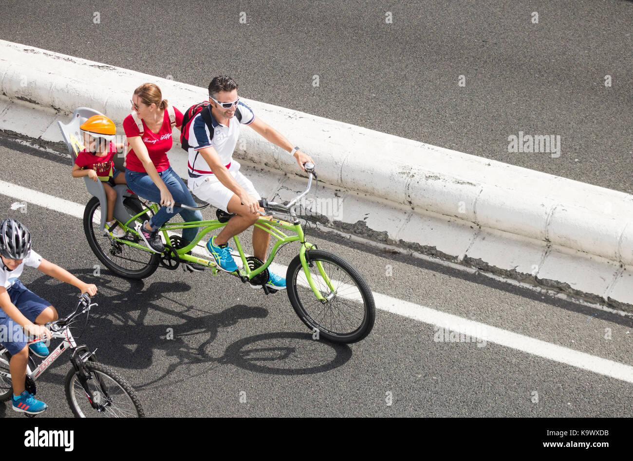 Family riding Tandem bicycle Stock Photo - Alamy