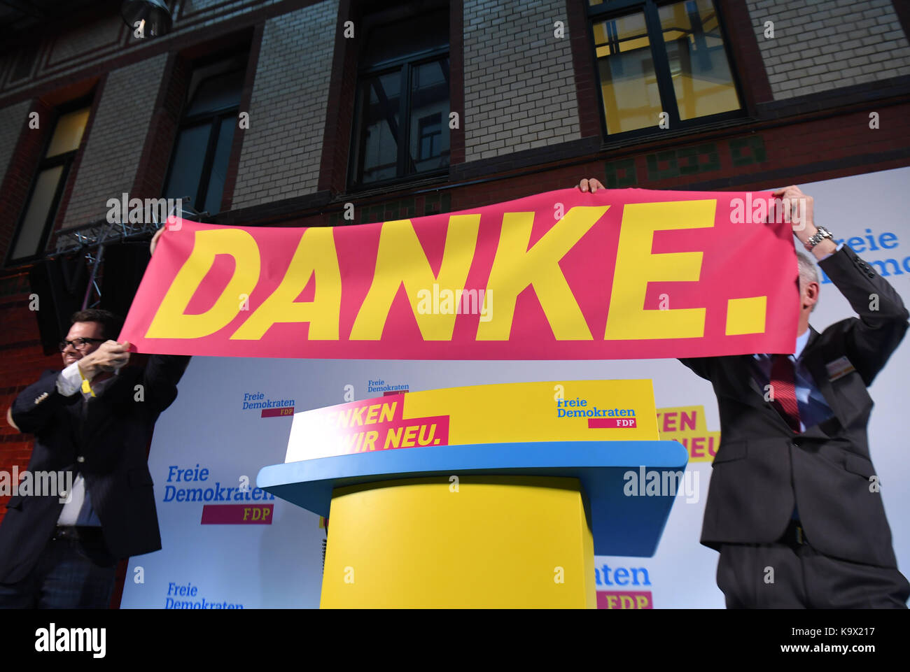 Berlin, Germany. 24th Sep, 2017. Two men hold up a banner that reads ...