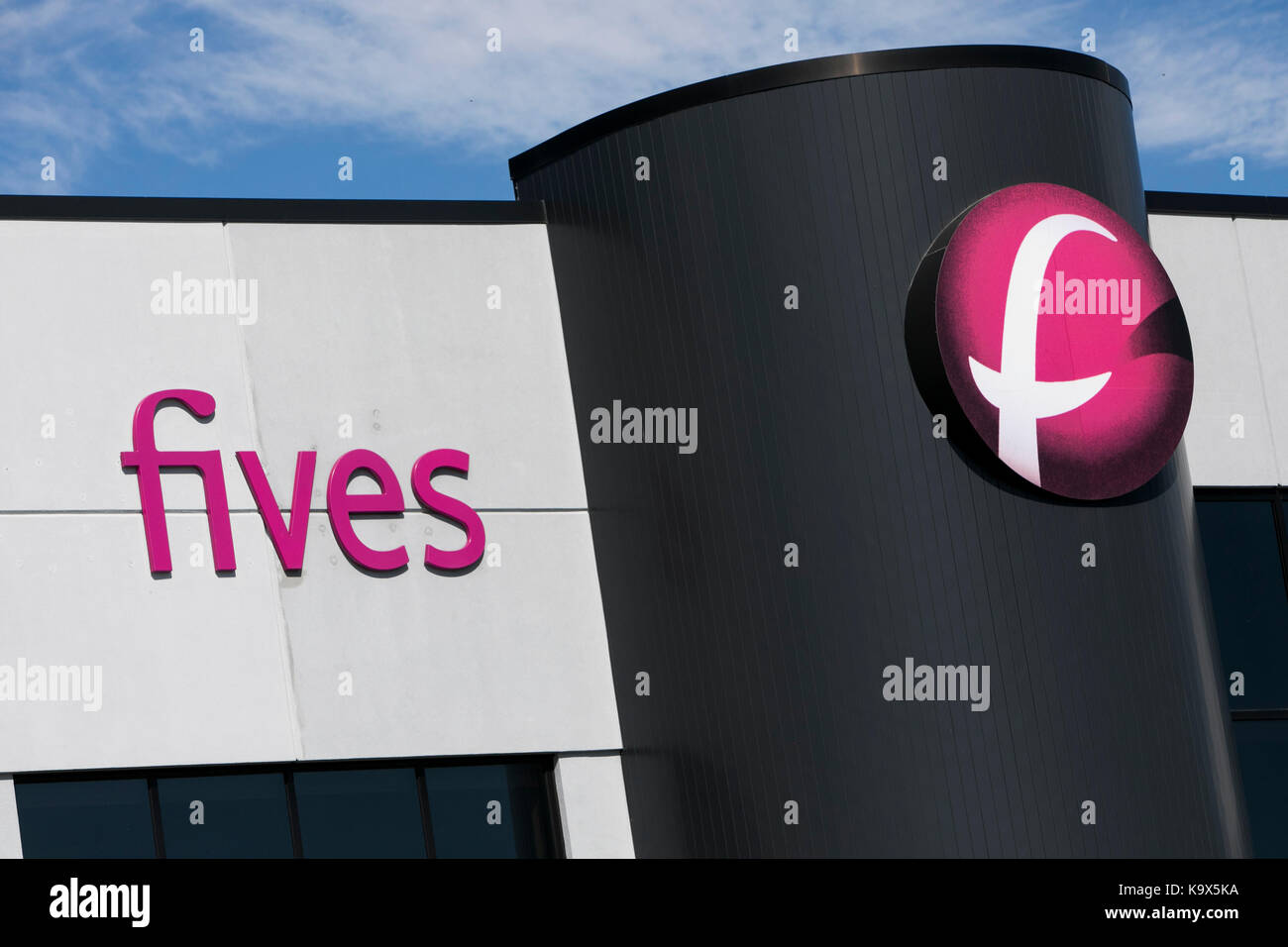 A logo sign outside of a facility occupied by the Fives Group in ...