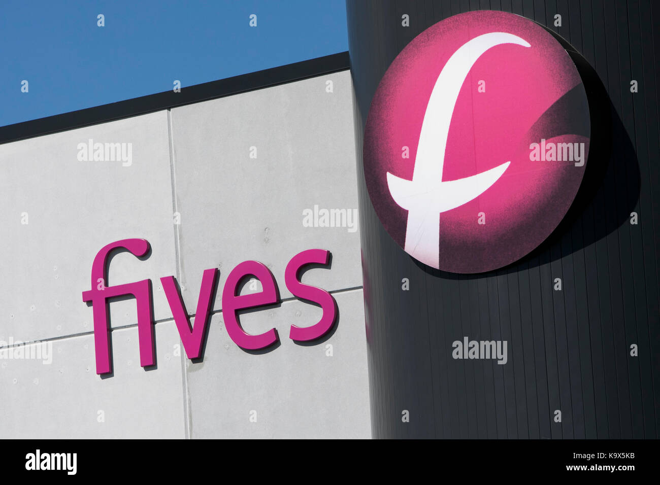 A logo sign outside of a facility occupied by the Fives Group in ...