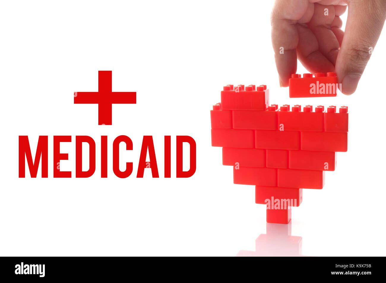 Medicaid, health conceptual. Hand help building heart, symbol of good ...